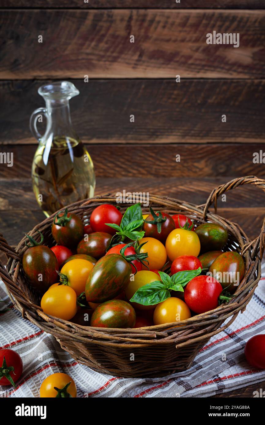 Multi-colored tomatoes in wickerwork basket. Different types of fresh ...
