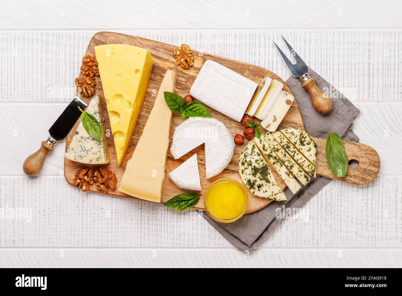 An assortment of various cheeses arranged on a board, highlighting ...