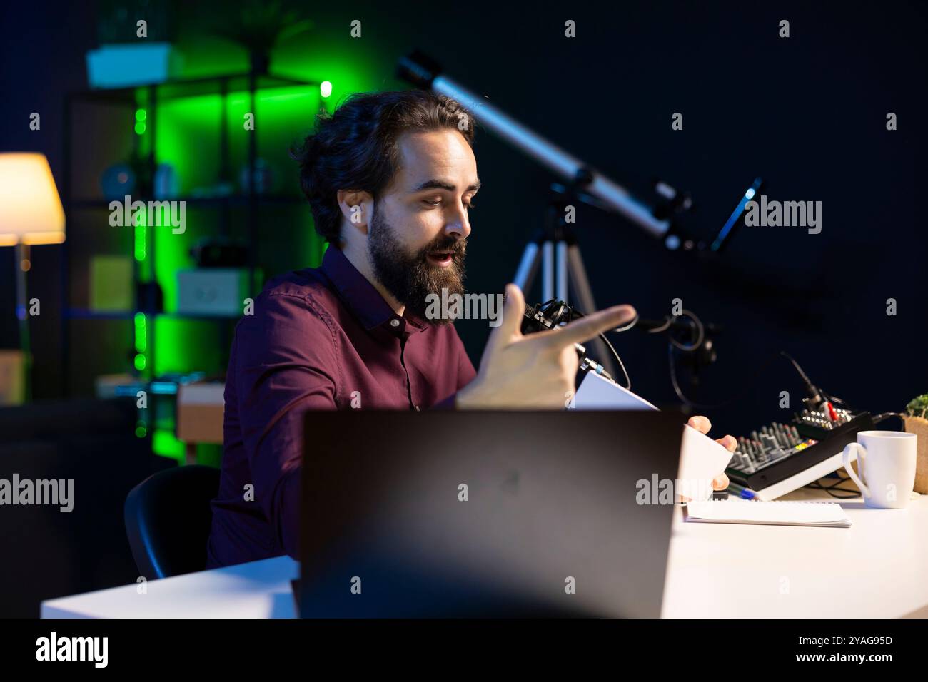 Content creator filming technology haul, following script from notes ...