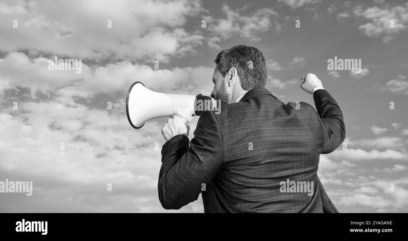 back view of businessman shout in loudhailer on sky background Stock ...