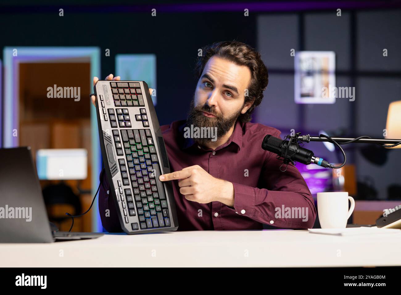 Influencer in studio reviewing gaming keyboard. Online show host ...
