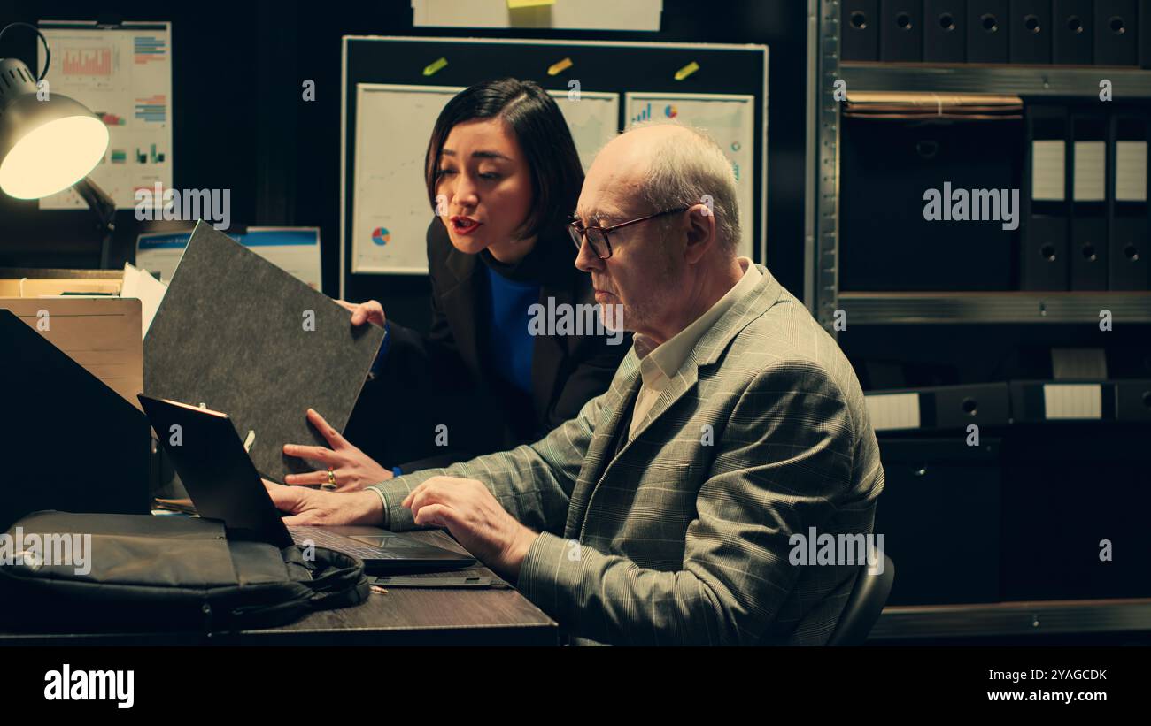 Private detectives reviewing forensic evidence folders in police ...