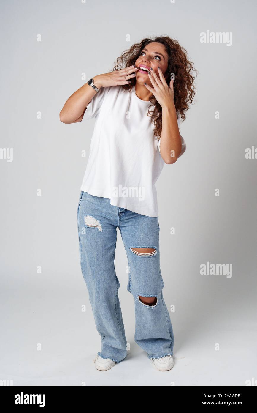 Surprised woman expressing strong emotions with wide eyes and raised ...