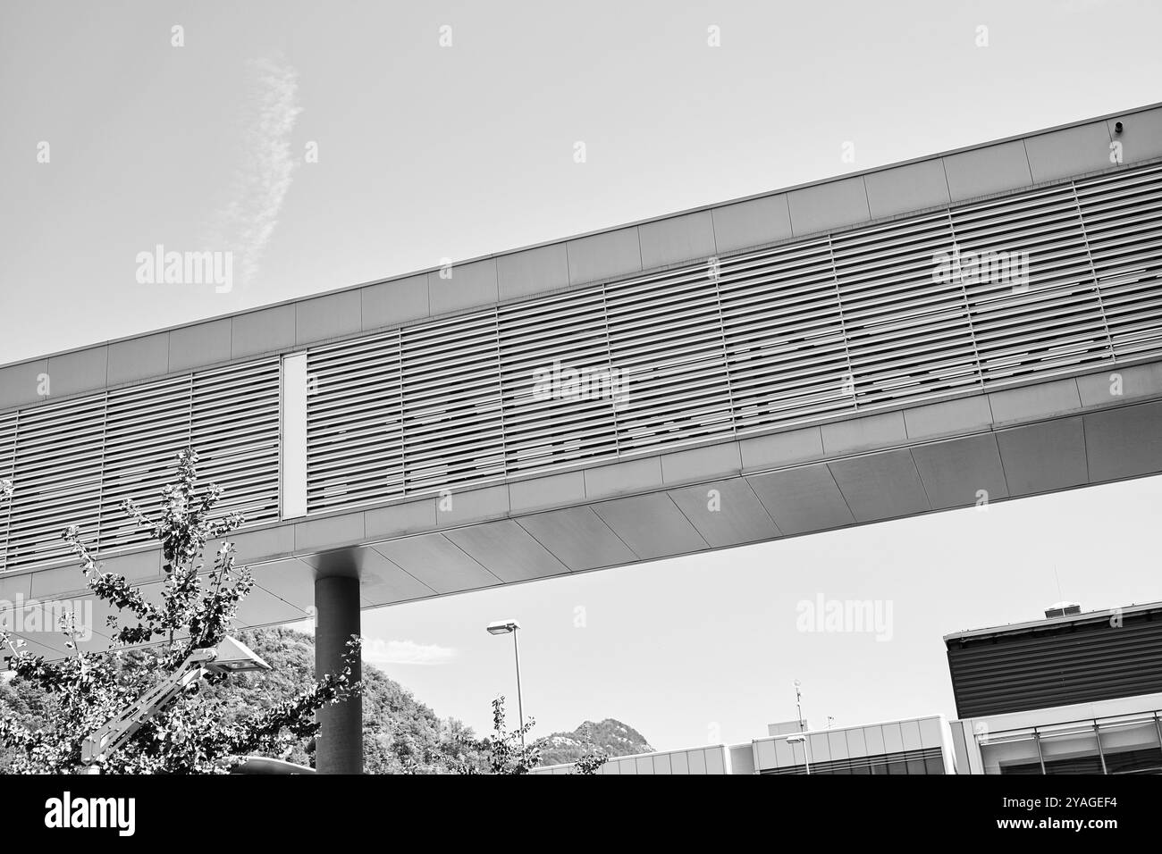 Modern skybridge connects two buildings with sleek design against a ...