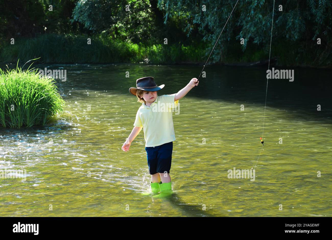 Little fisherman ready to go fishing. Young boy fishing in a forest ...