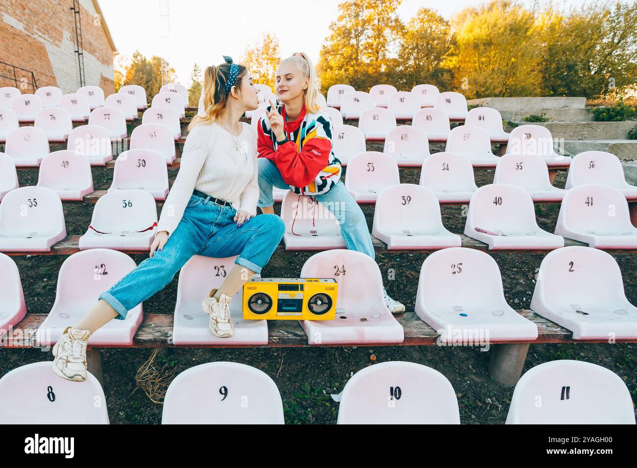 Romny, Ukraine, October 13, 2018: Two young women sit in an empty ...