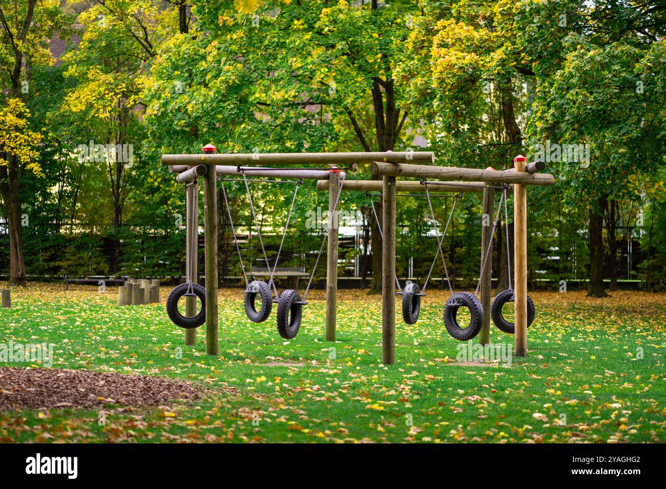 View of a swing made from car tires on a playground Stock Photo - Alamy