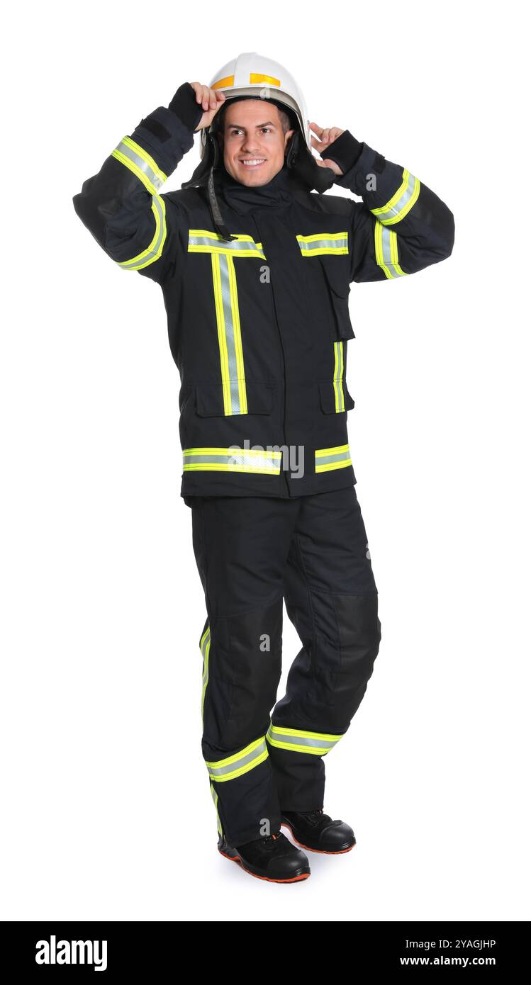 Full length portrait of firefighter in uniform wearing helmet on white ...