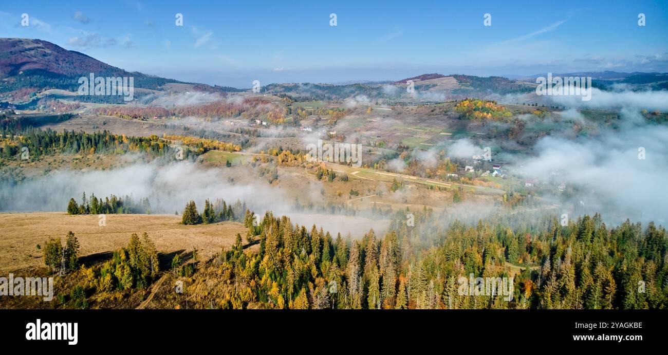 Picturesque village nestled in rolling hills, bathed in autumn colors ...