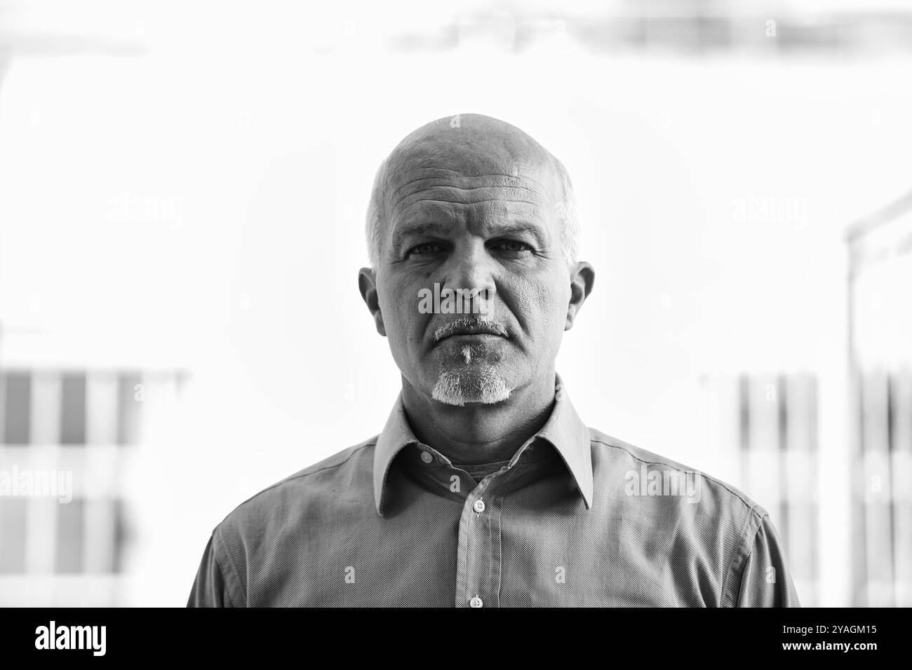 Black and white portrait of a confident senior manager posing in an ...