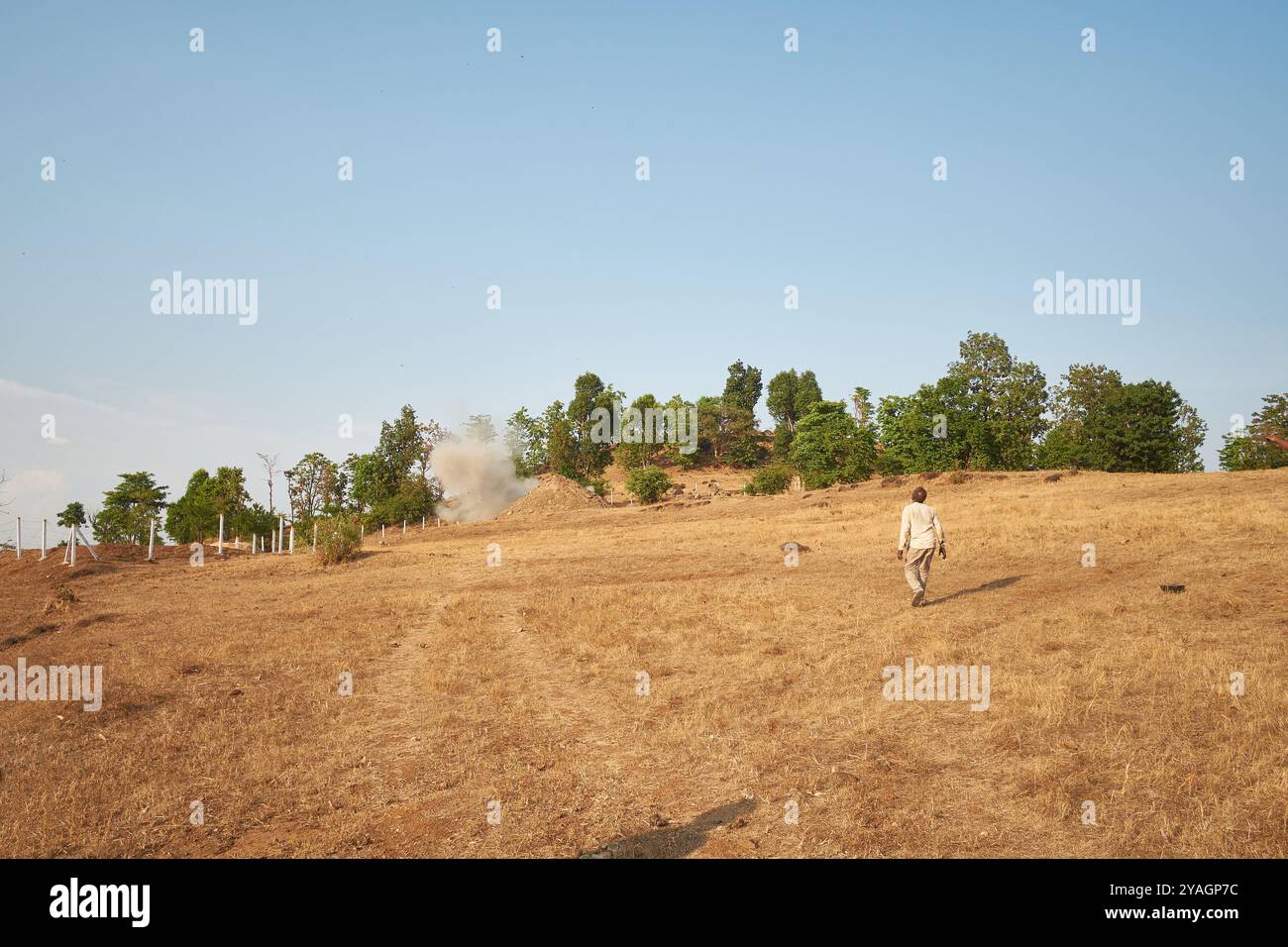 Well diggers set off a controlled explosion to dig through basalt rock ...