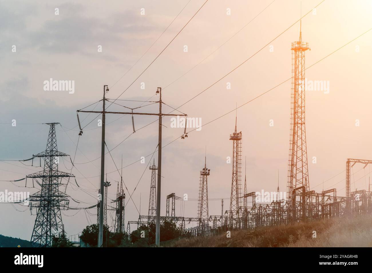High voltage electric distribution network at sunset. Power ...