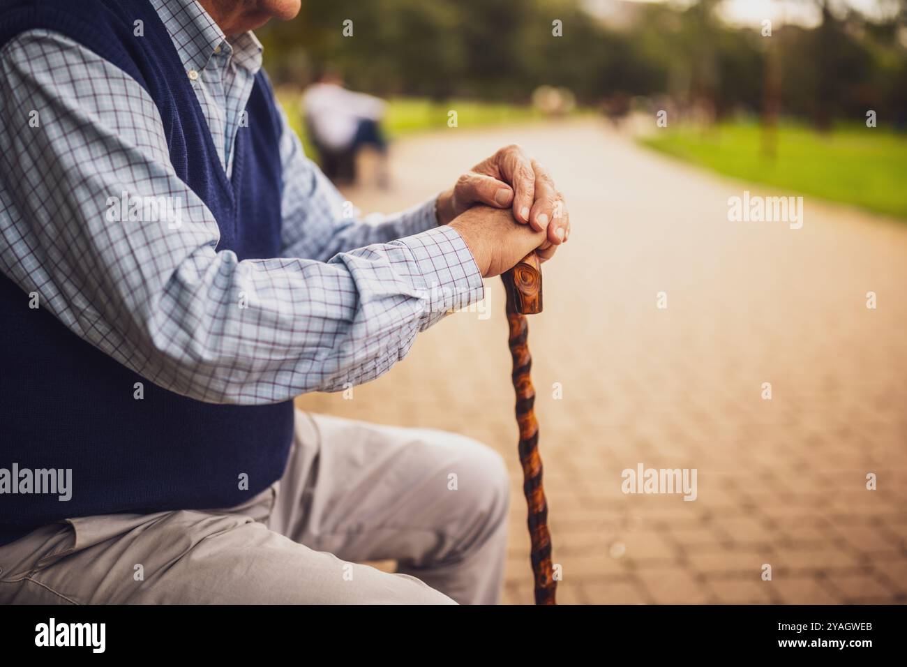 Close up image of senor men hand with walking cane. Senior man sitting ...