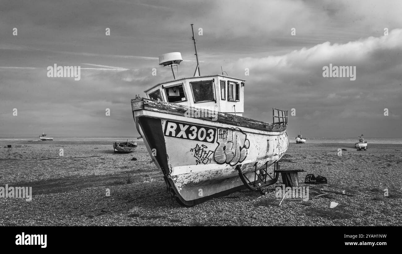 A black and white image of an old abandoned derelict boat in Dungeness ...