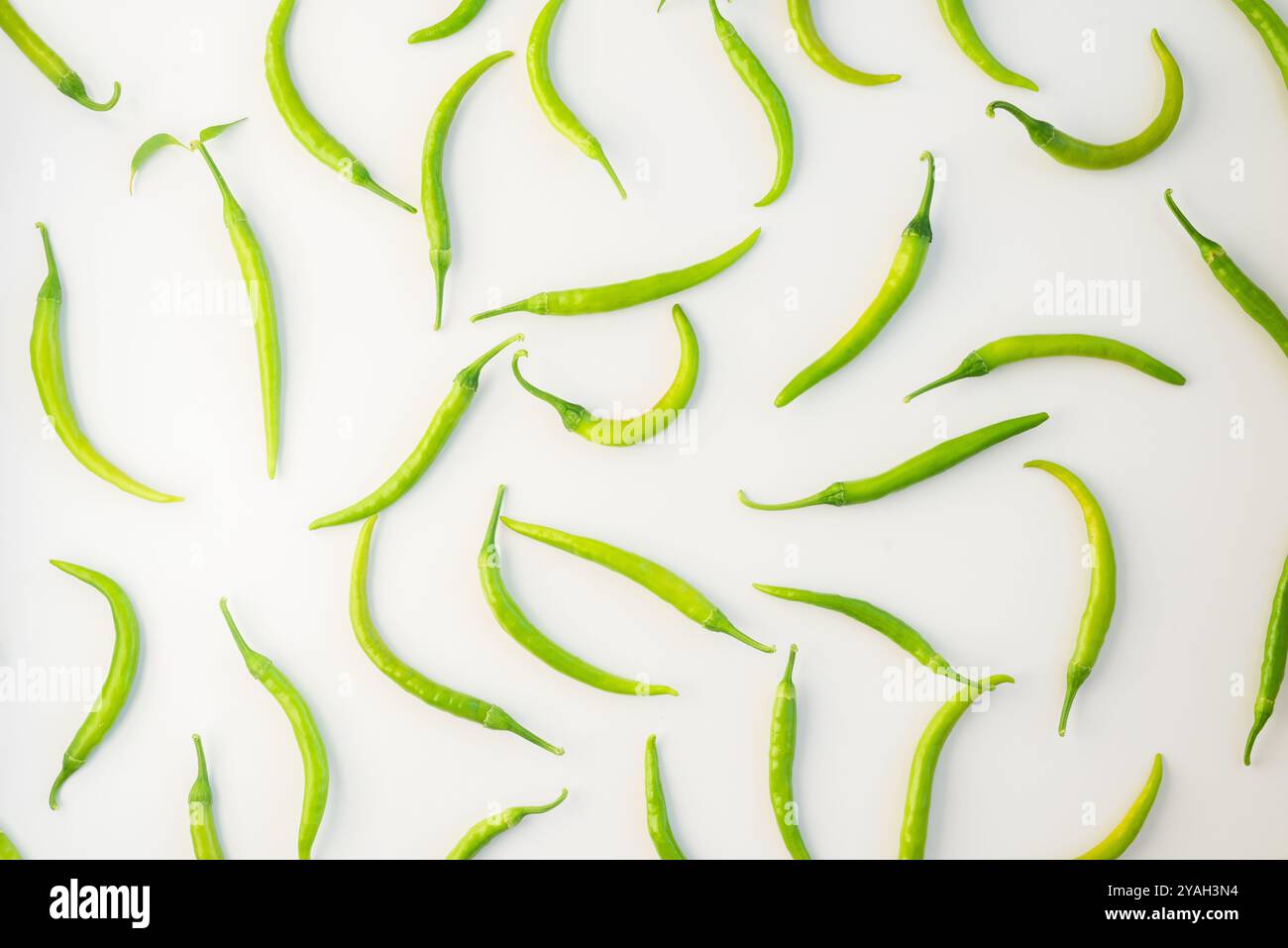 Scattered fresh green chilies, vibrant produce and organic freshness ...