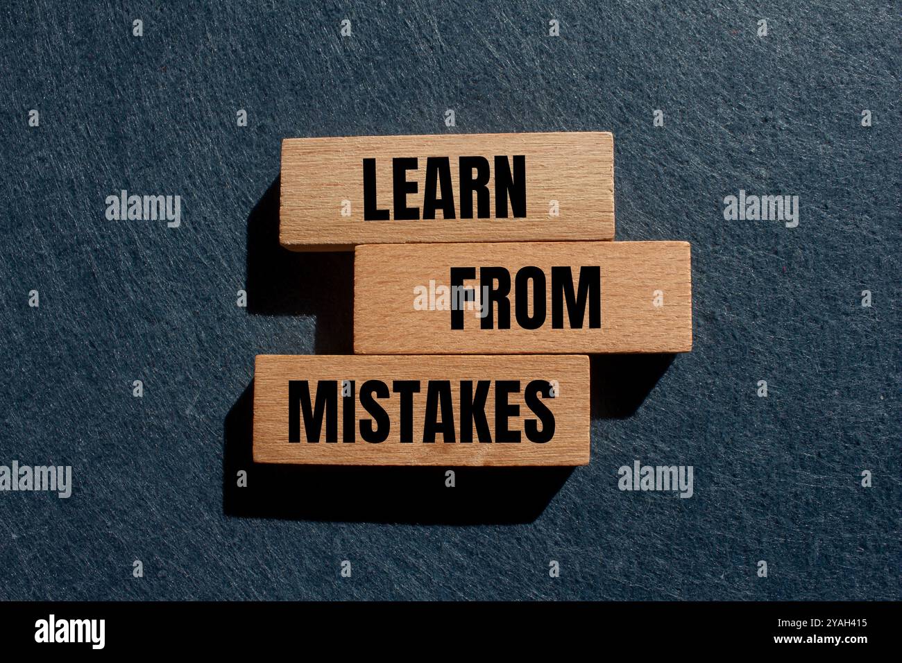 Learn from mistakes message written on wooden blocks with gray ...