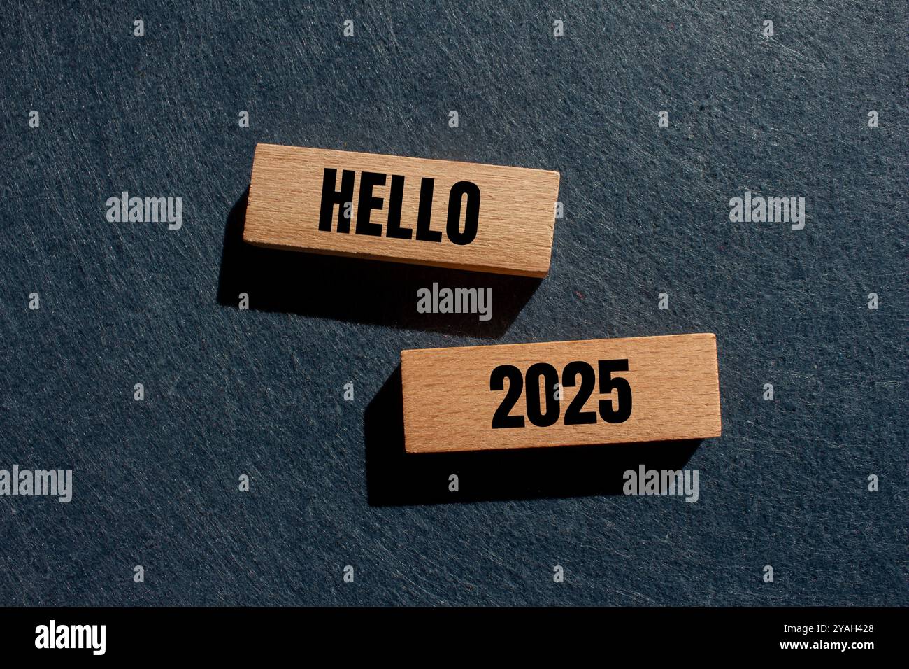 Hello 2025 message written on wooden blocks with gray background ...