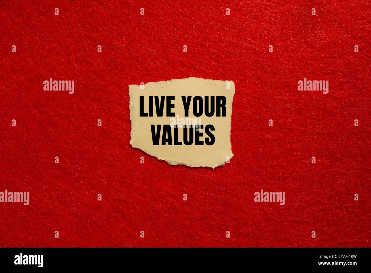 Live your values message written on ripped torn paper piece with red ...