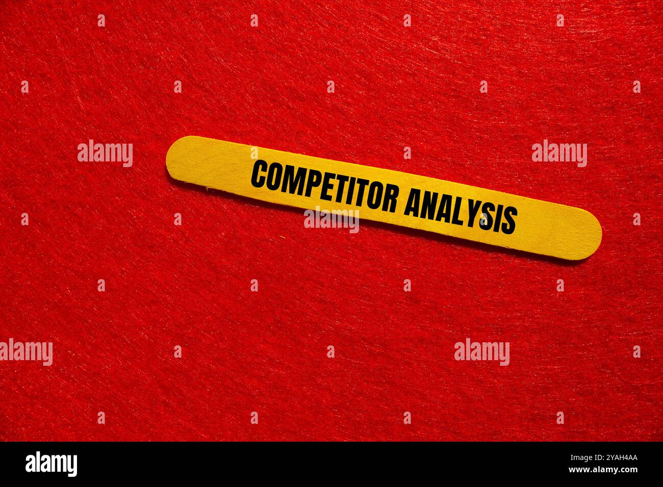 Competitor analysis message written on yellow wooden stick with red ...