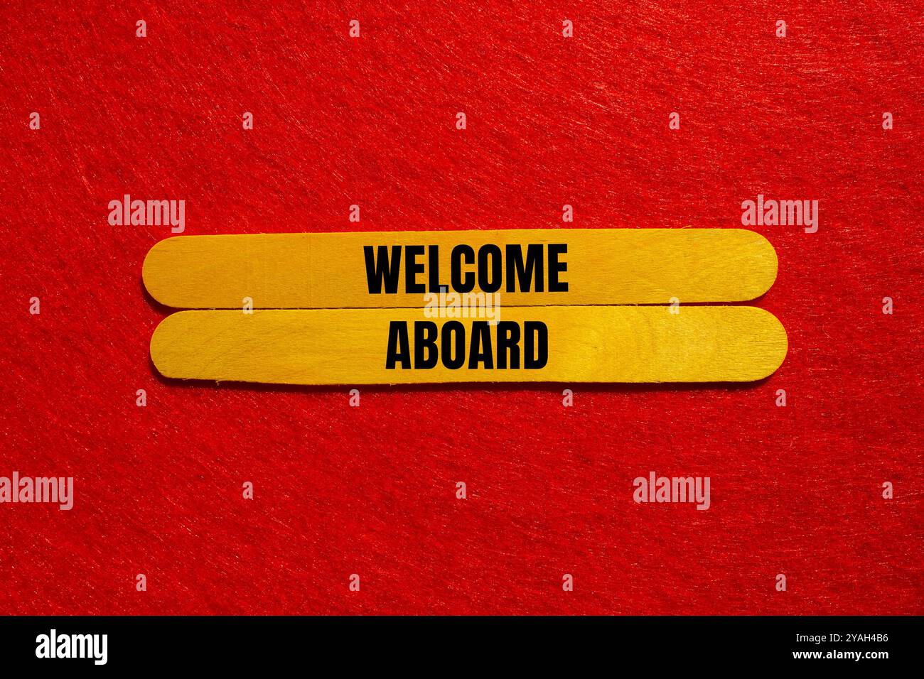 Welcome aboard message written on yellow wooden sticks with red ...