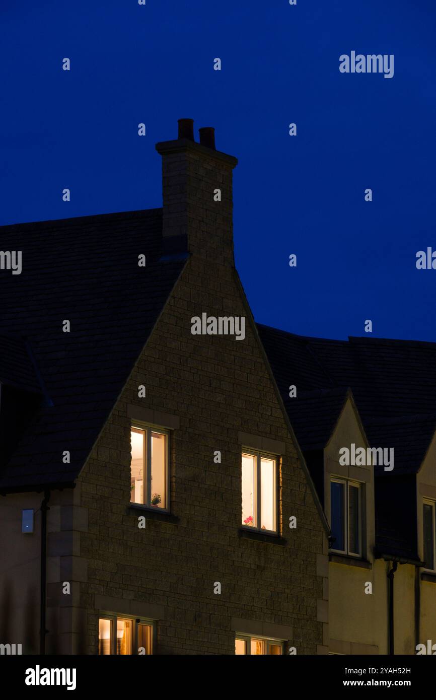Lights shining through the windows of an apartment block at night Stock ...