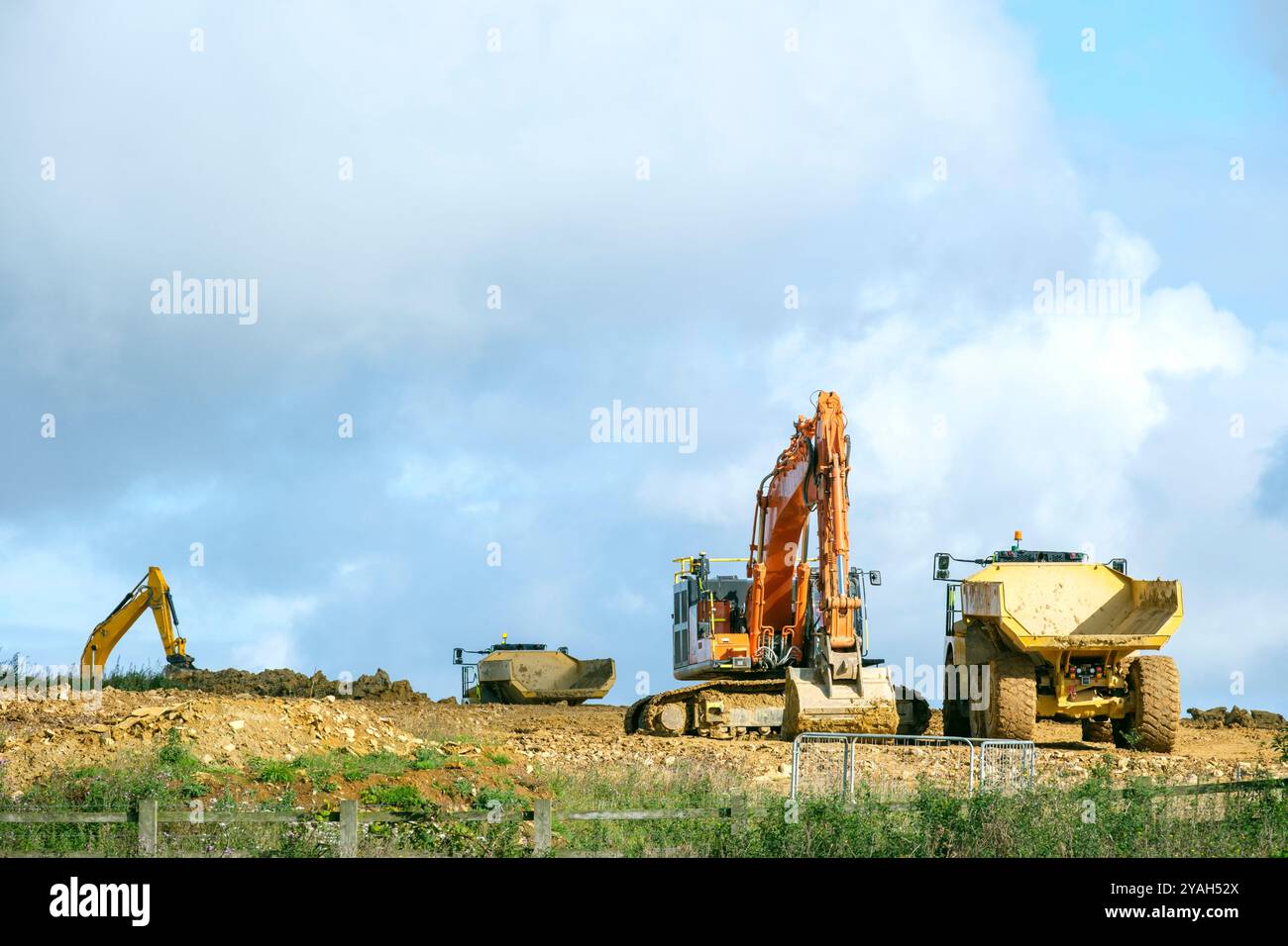 Earth moving machinery, diggers and lorries on a construction site in ...
