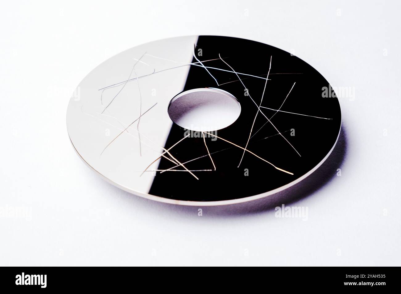 A single hard disc from a computer with scratched surface on a white ...