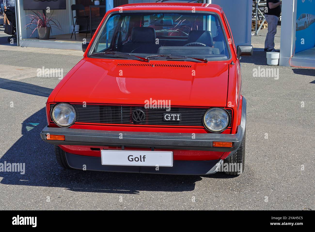 Red volkswagen golf gti is parked on an asphalt road, showcasing its ...