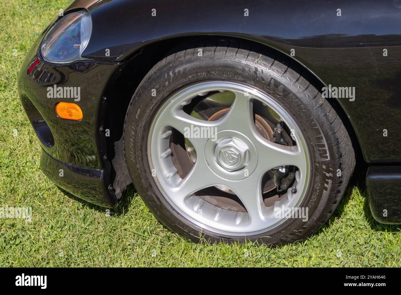 Close up of an alloy wheel of a black dodge viper rt10 parked on grass ...