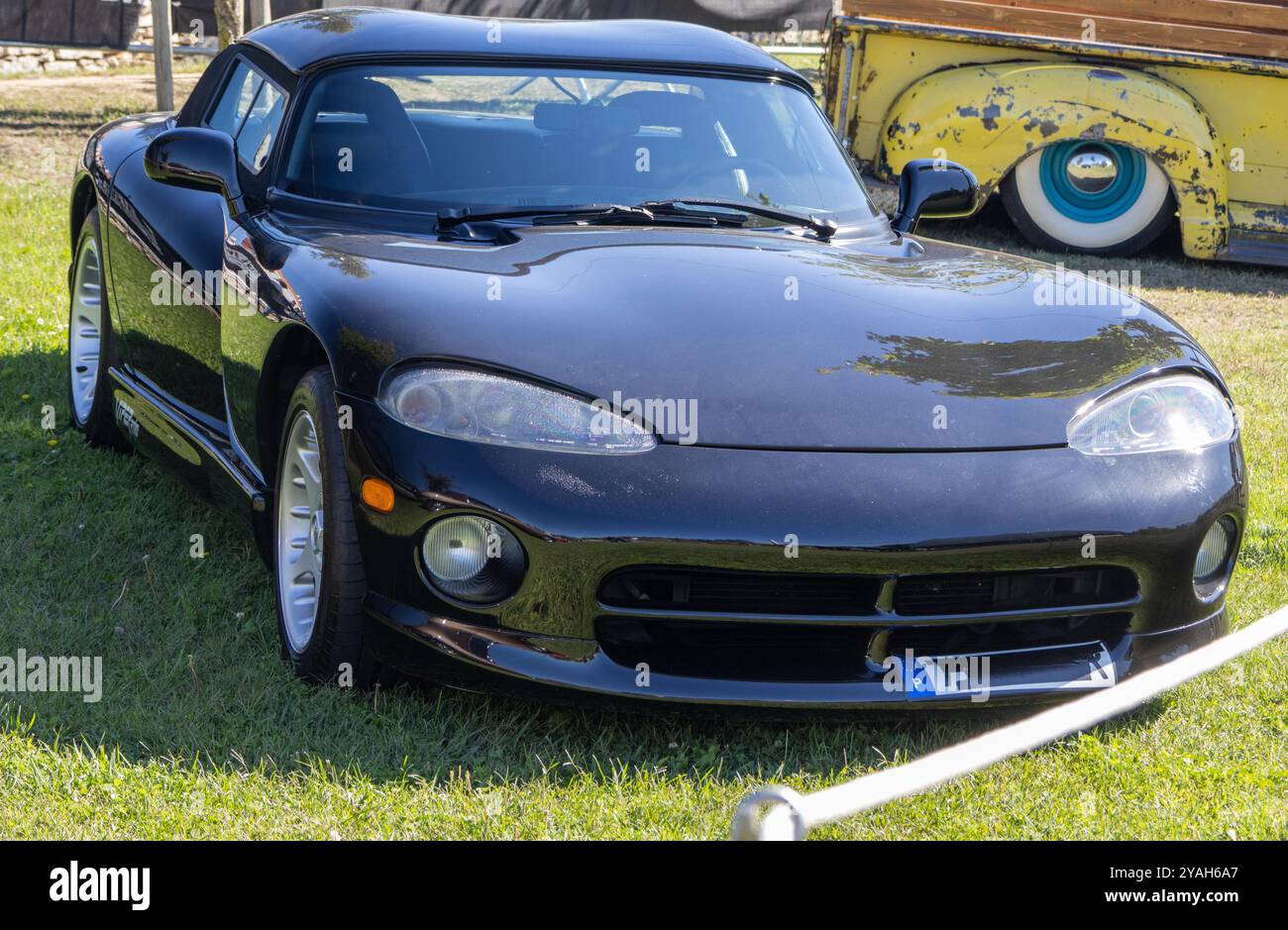 Gleaming black dodge viper rt10 convertible basking in the sun at a ...