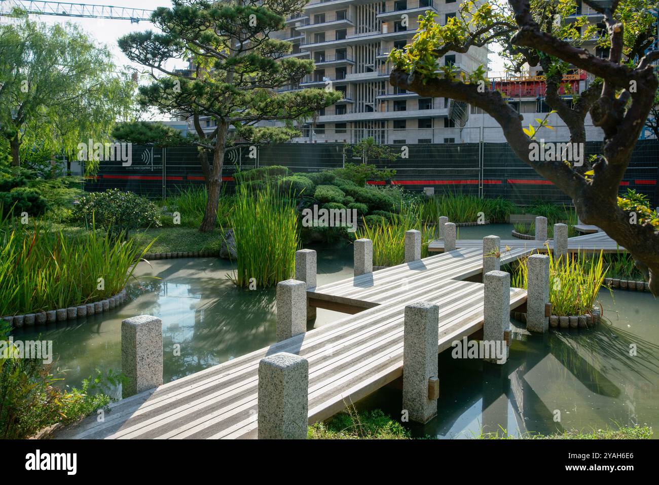 Amazing zigzag wooden bridge in Japanese garden of Monaco. behind new ...
