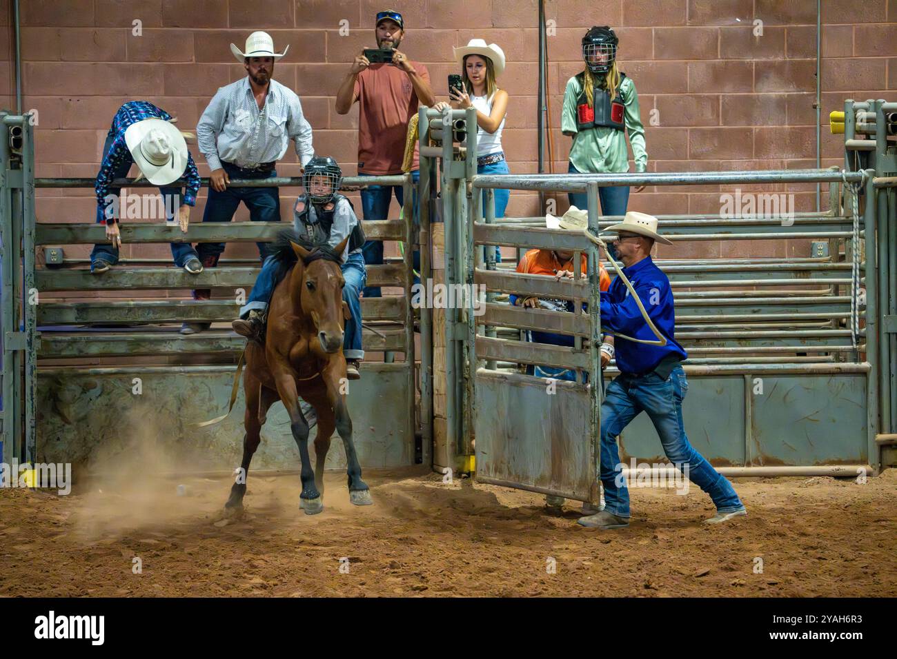 A young cowgirl rides a bucking horse at the Moab Junior Rodeo in Moab ...