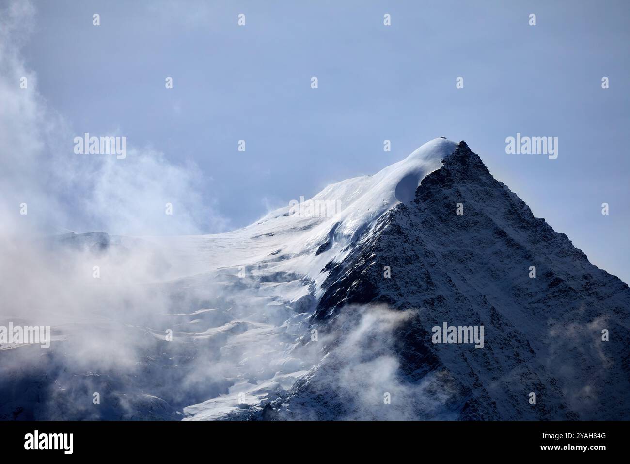 Mist shrouded peaks and slopes forming panoramic views of the mountains of the Alps above ...