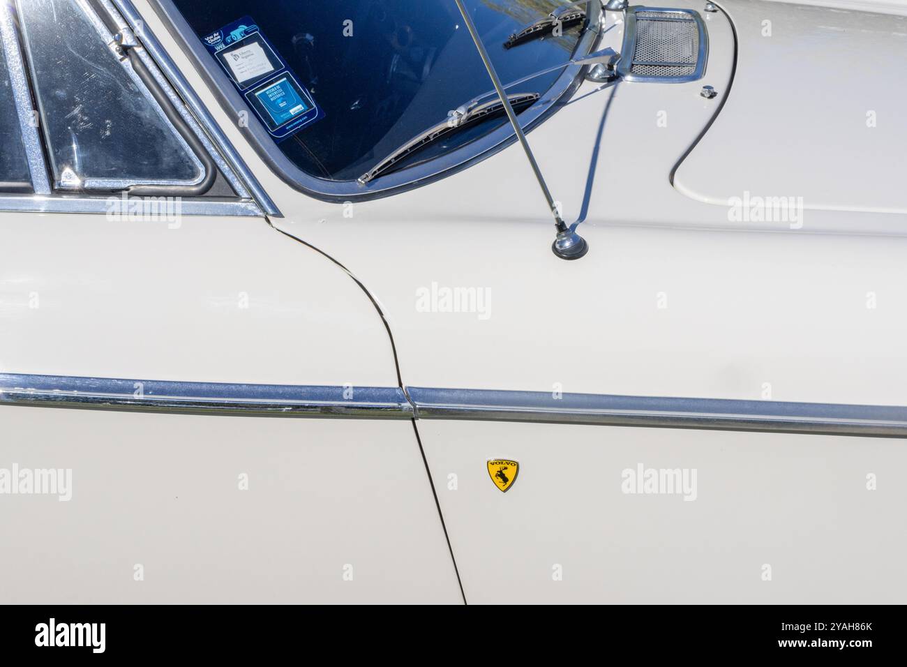 Side view of a white volvo p1800s sporting a ferrari prancing horse ...