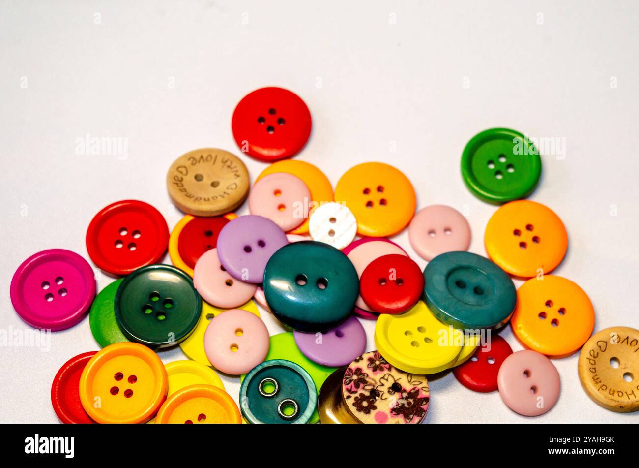 Chaotic collection of coloured buttons on a white background Stock ...