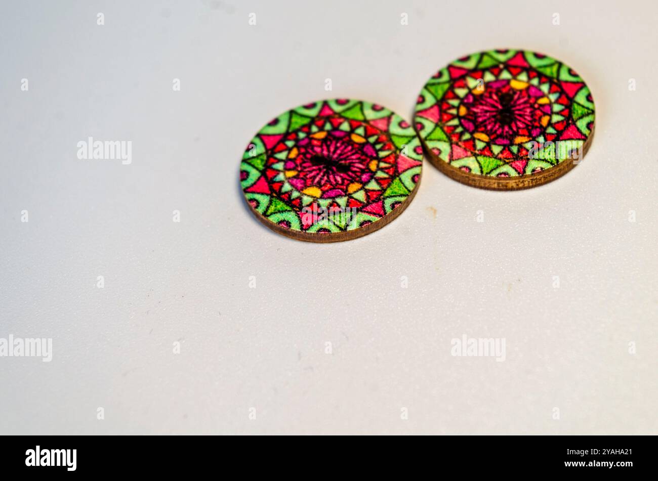 Two colourful buttons on a white background Stock Photo - Alamy