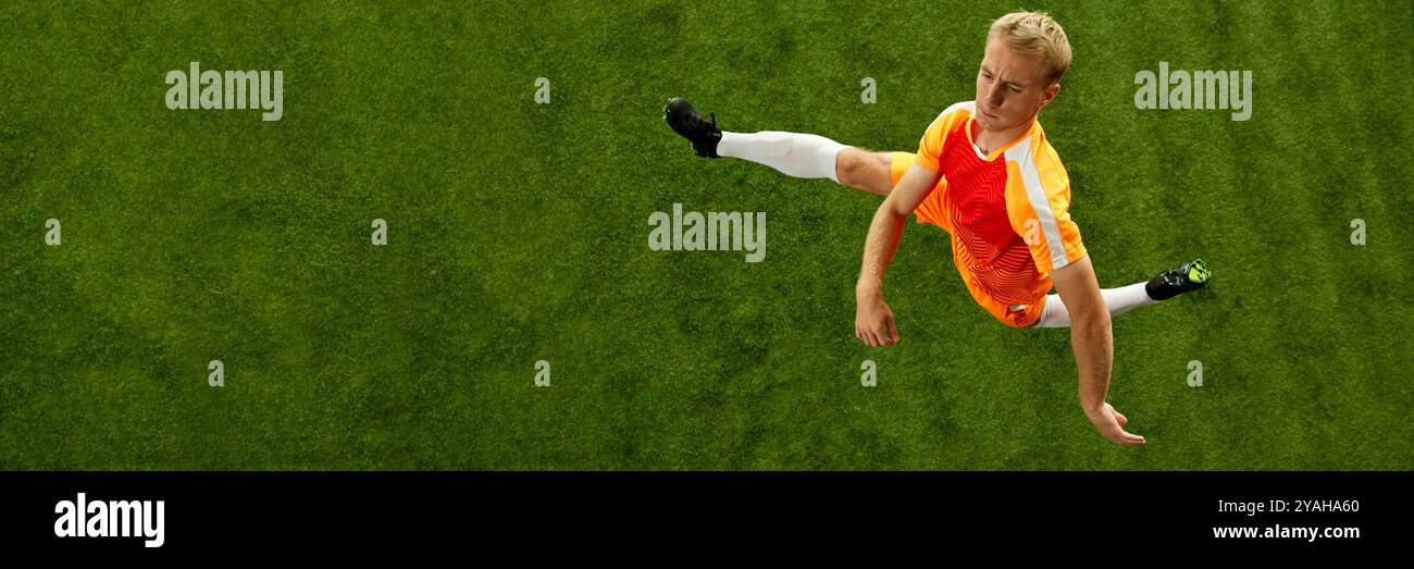 Banner. Leaping through air, this footballer performs spectacular kick ...
