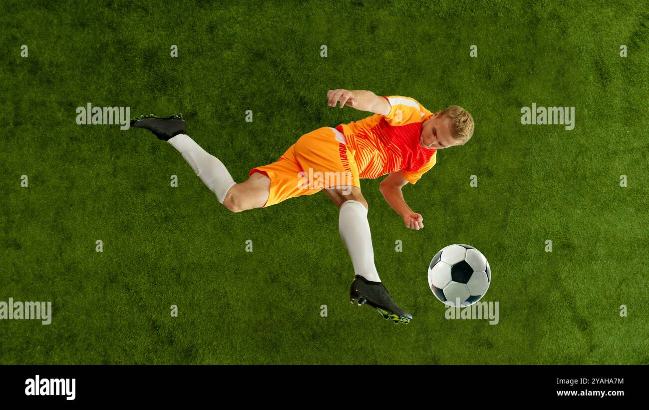 Football player kicks ball in motion demonstrating strength and ...