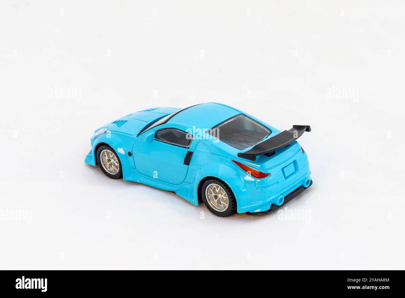 Rear spoiler view of a blue toy sports car on white background Stock ...