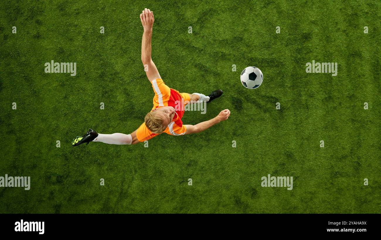 Powerful move. Footballer aims for ball with precision. His body ...