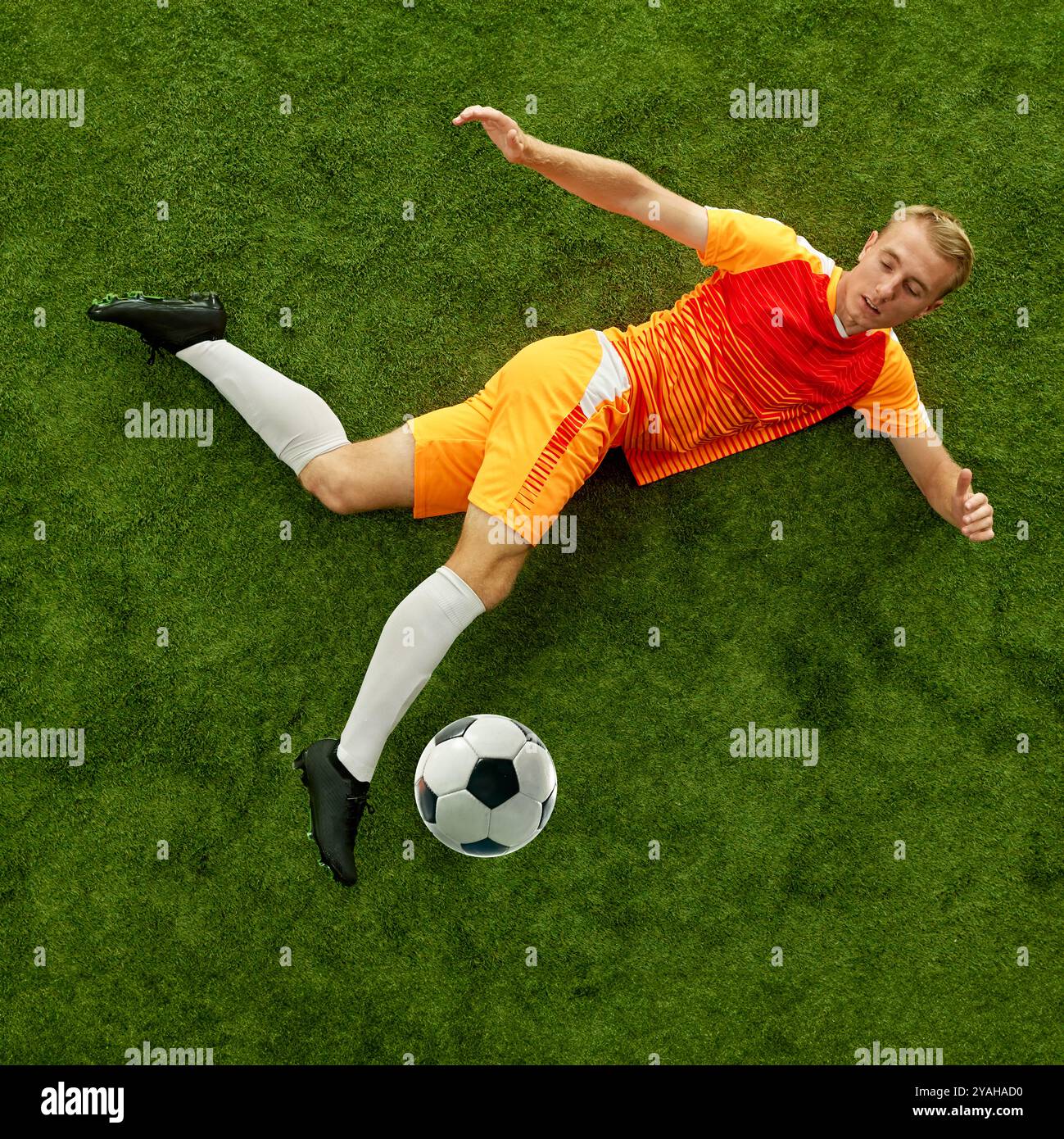 As he takes fall, soccer player's attention remains on football ...