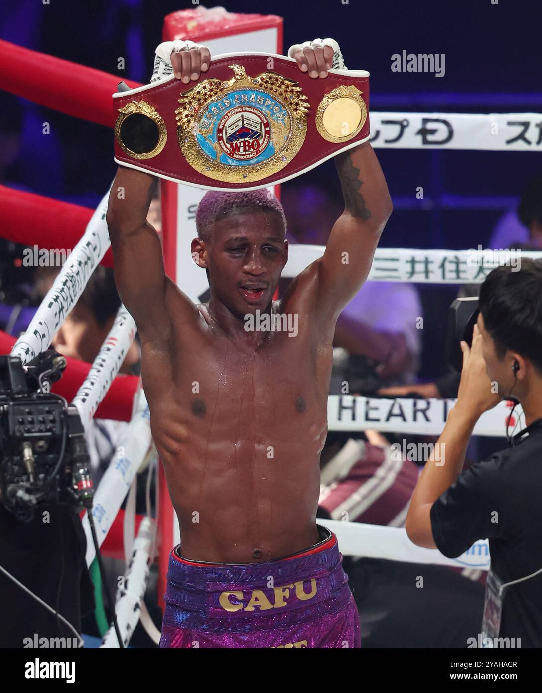 South Africa's Phumelele Cafu raises the champion belt above his head ...
