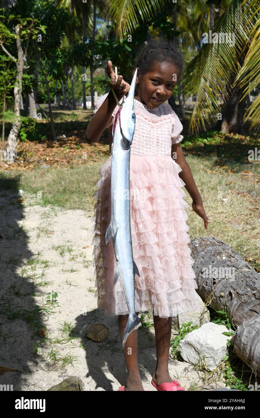 Nosy Be, girl showing a freshly caught fish. Madagascar Stock Photo - Alamy