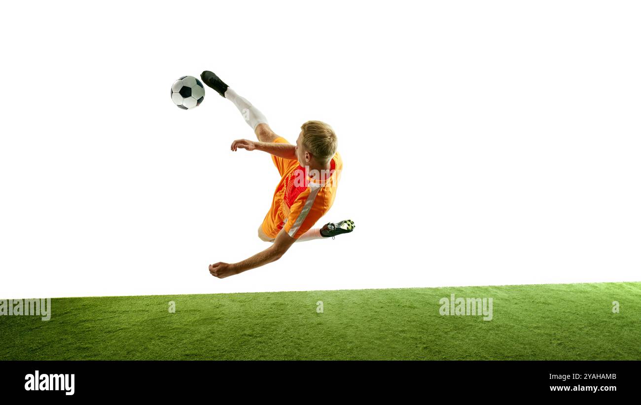 Football player in mid-motion demonstrates dynamic jump kick, creating ...