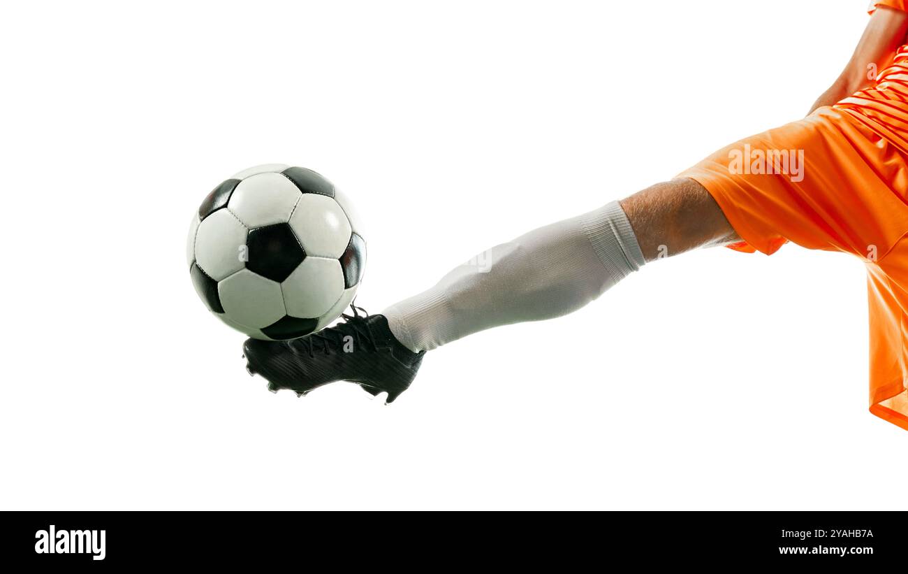 Close-up shot of football player's leg striking ball, perfectly timed ...
