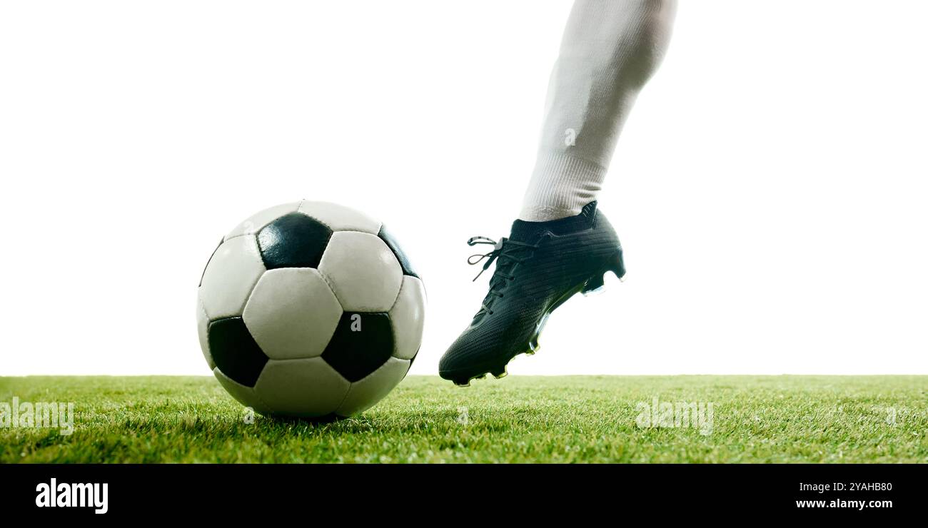 low-angle shot of football player about to kick ball against white ...