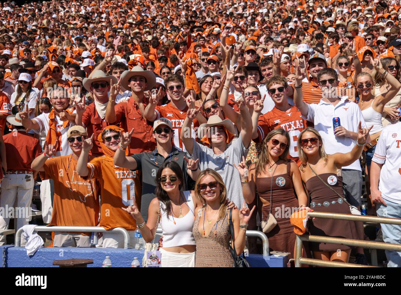 DALLAS, TX - OCTOBER 12: Student fans smile and hold up the Hook 'Em ...