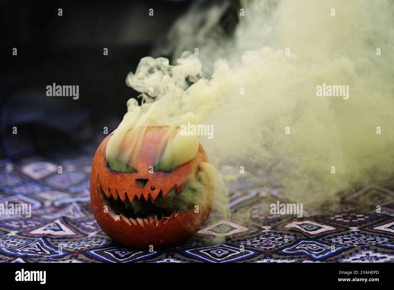 Carved pumpkin jack-o-lantern with color smoke bomb Stock Photo - Alamy