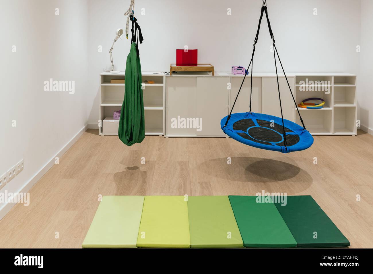 Sensory integration therapy room with swings and mats for children ...