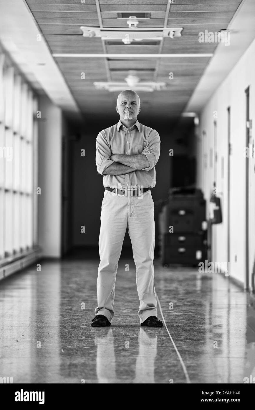 Black and white portrait of a confident mature professor standing in a ...